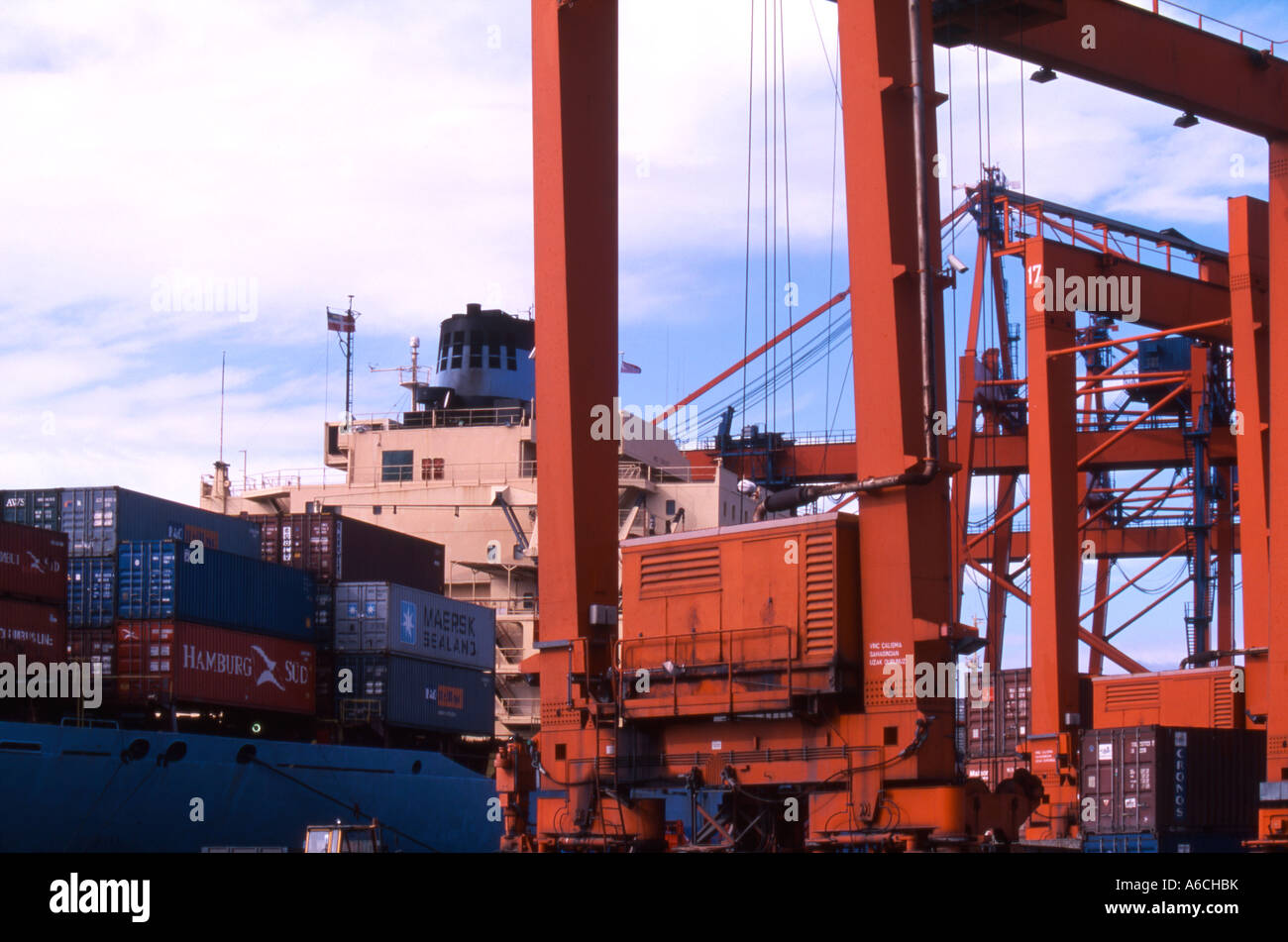 Cargo ship loading and unloading containers at the freight terminal ...