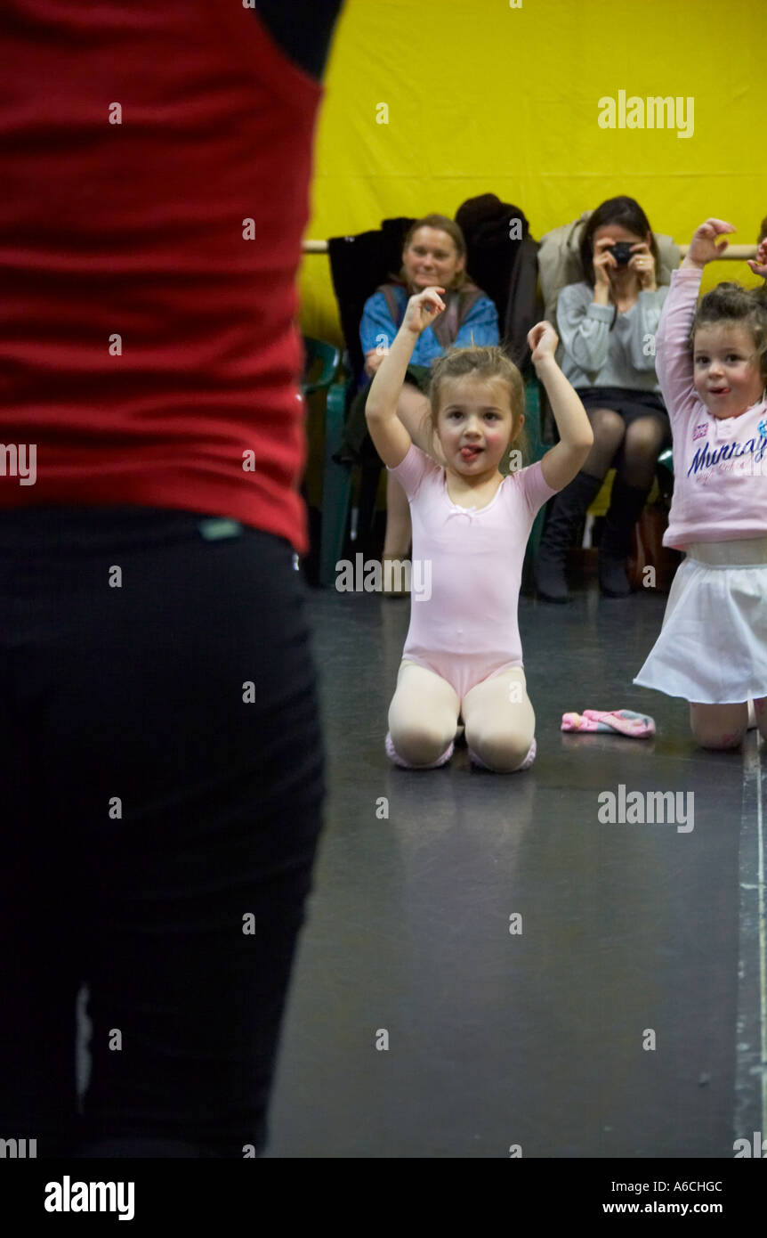 Child sticking out tongue during dance lesson Stock Photo - Alamy