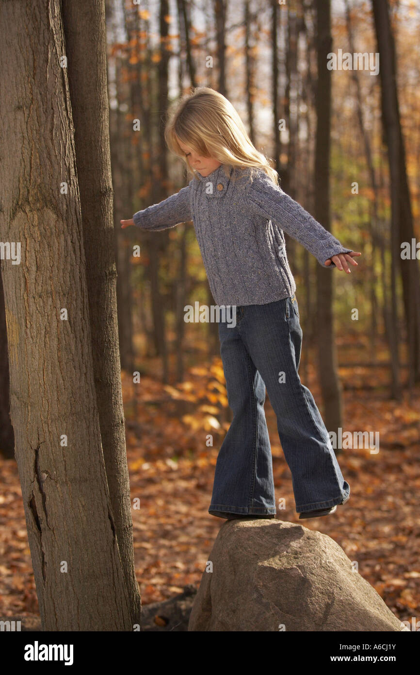 Girl Standing on Rock Stock Photo - Alamy