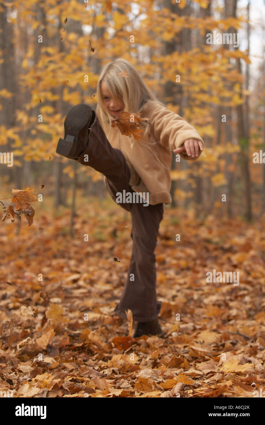 Girl Kicking Leaves Stock Photo - Alamy