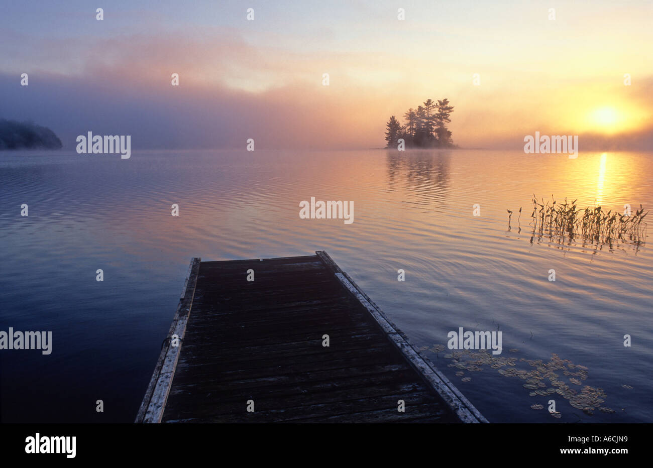 Canada Ontario Lake MacKay sunrise over lake with island in distance ...