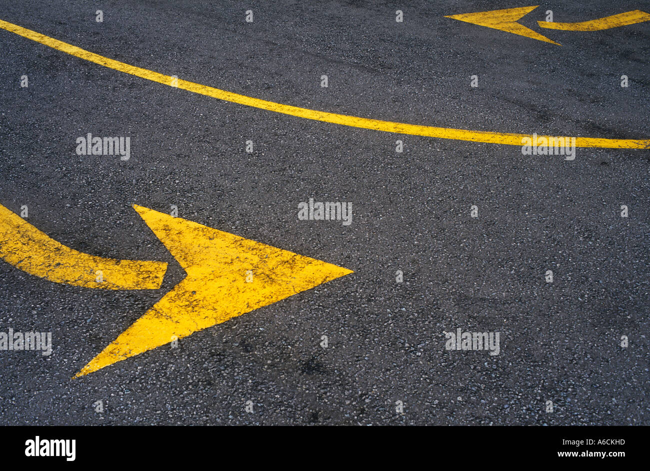 Two traffic arrows on a road facing opposite directions Stock Photo - Alamy