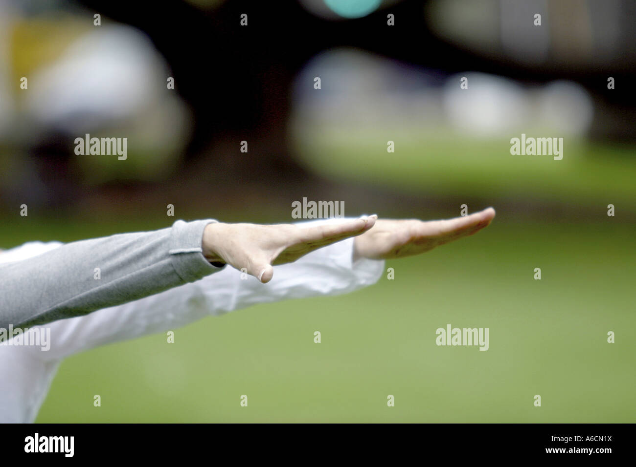 Two people stretching their arms out Stock Photo - Alamy
