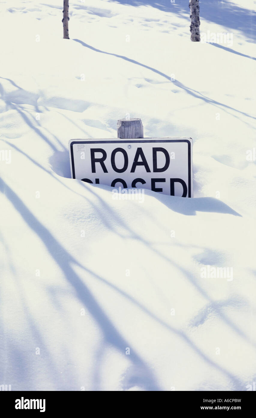 A road closed sign buried in snow Stock Photo - Alamy