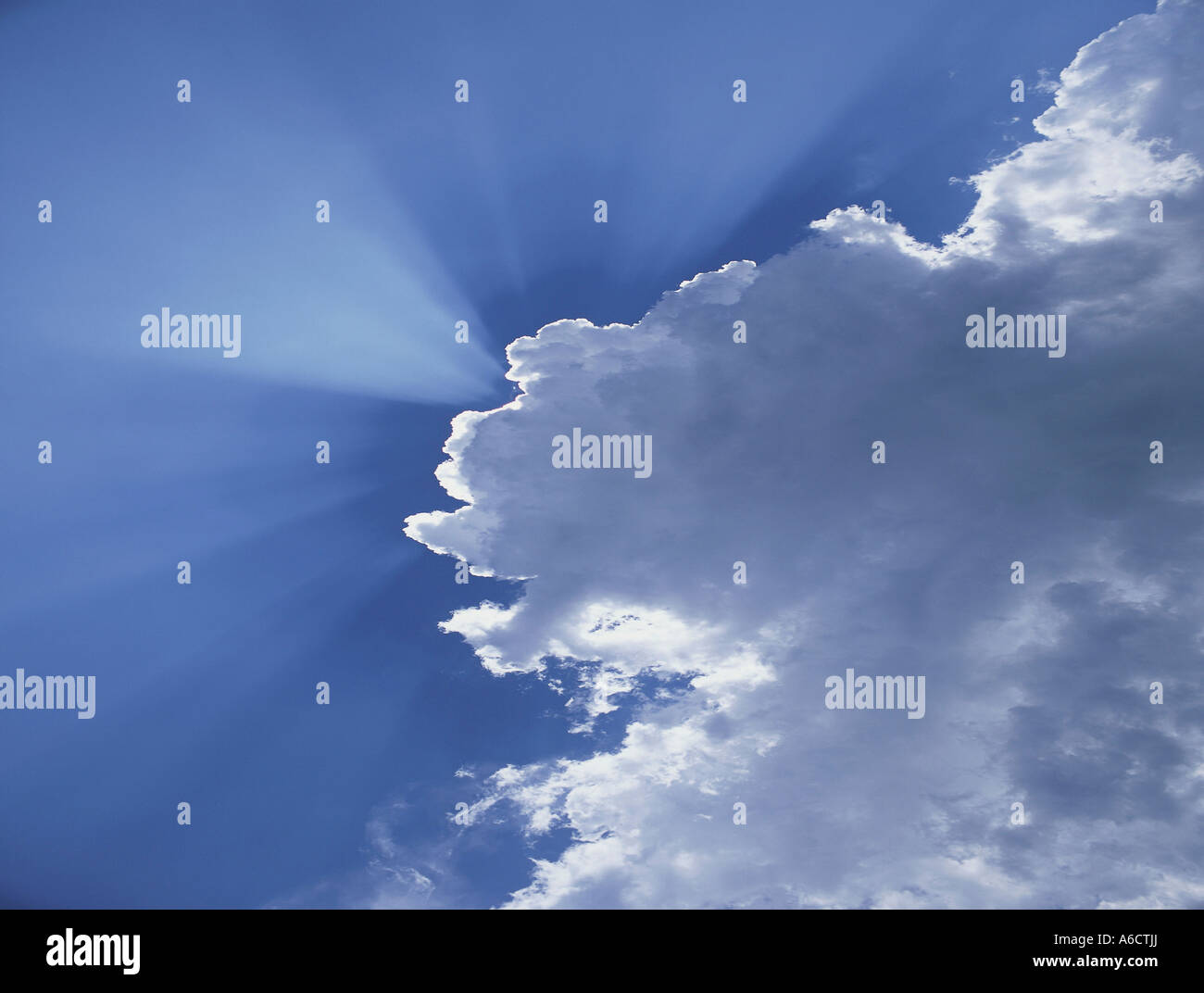 Sunbeams shining through clouds Stock Photo - Alamy