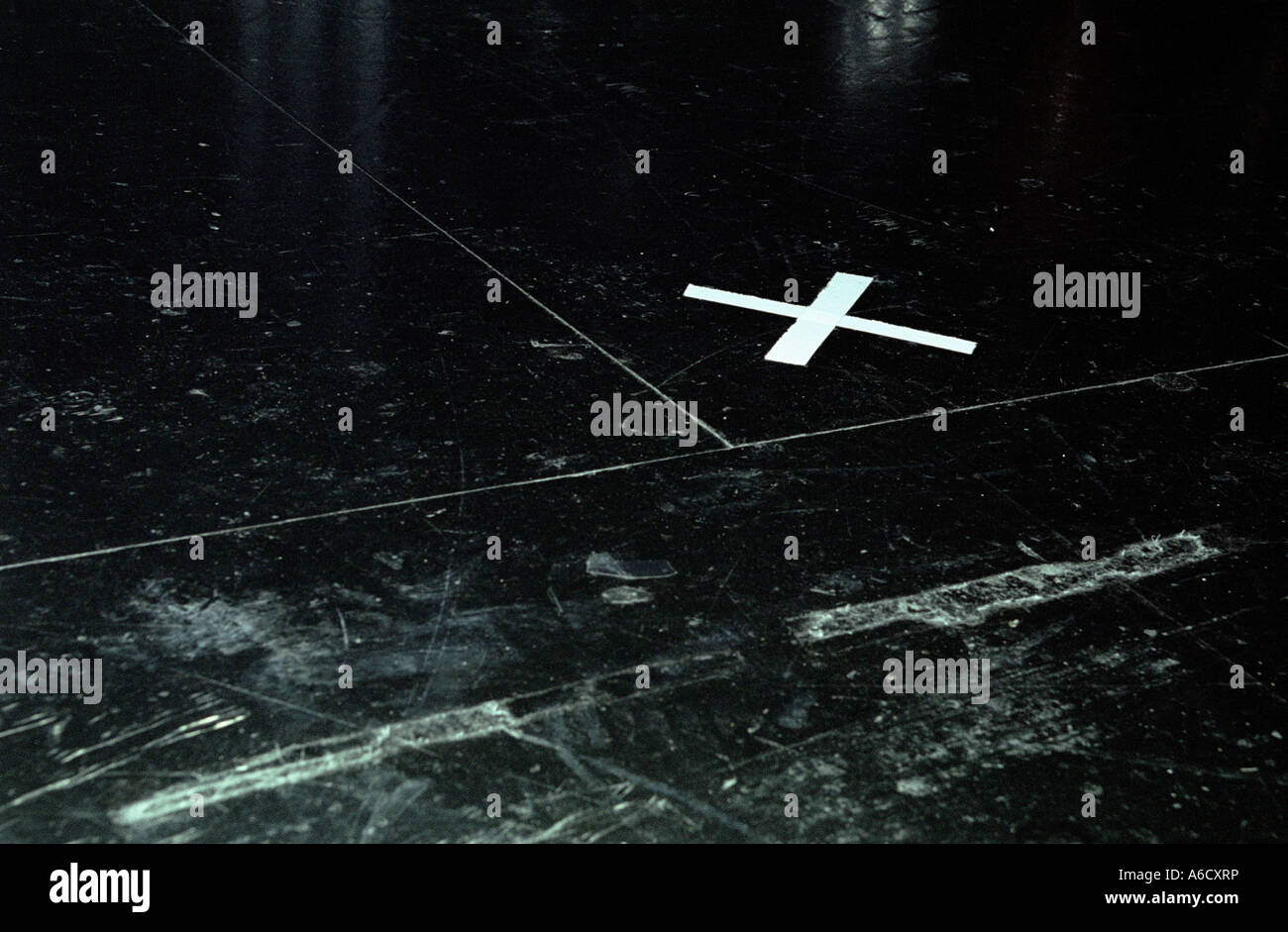 A cross on stage to mark where a performer should stand like x marks ...