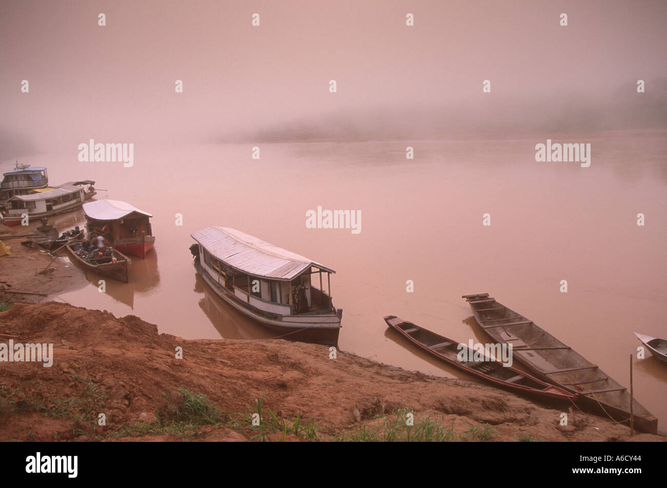 Boats at dawn on the Purus River in the Amazon rainforest Brazil Stock ...