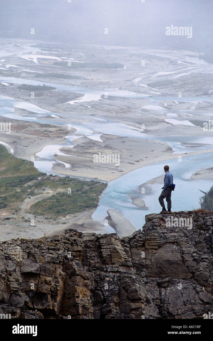 Canada Northwest Territories Bonnet Plume River Man on ridge overlooked ...