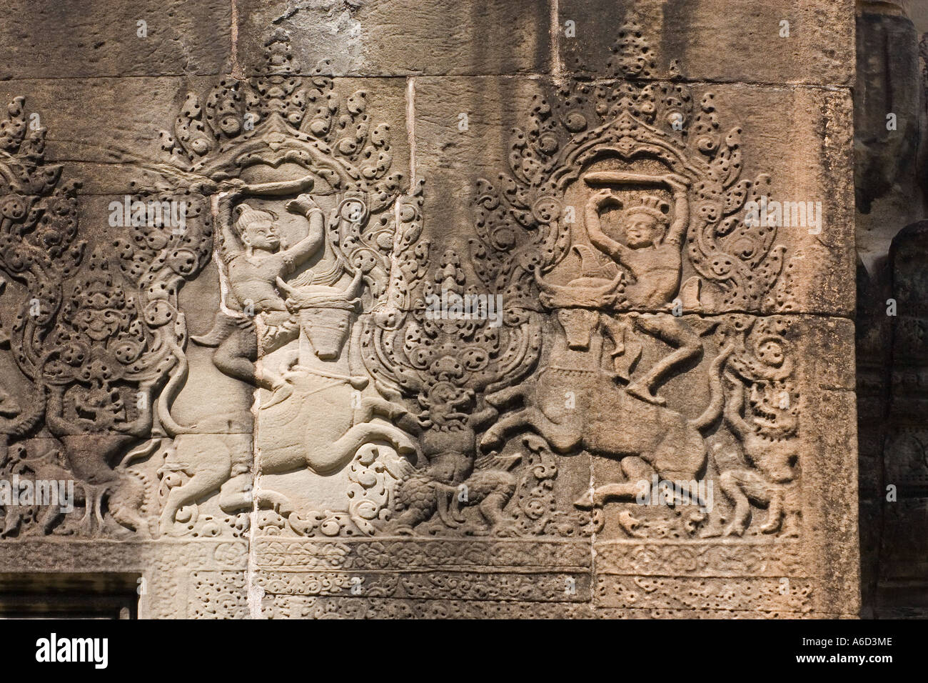 A stone carved bas relief from Hindu mythology of a battle atop bulls ...