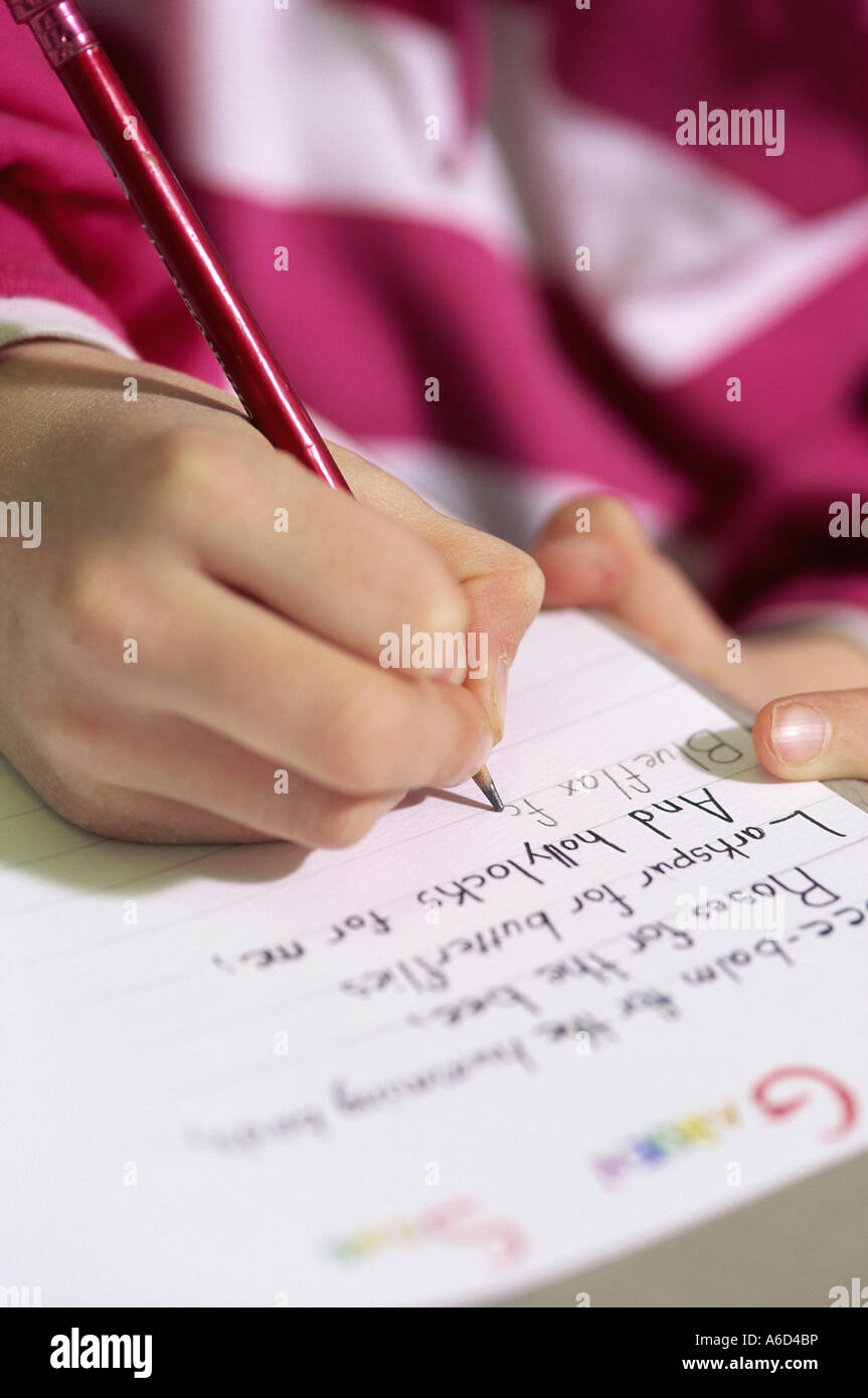 Close-up of a child writing with a pencil on paper Stock Photo - Alamy