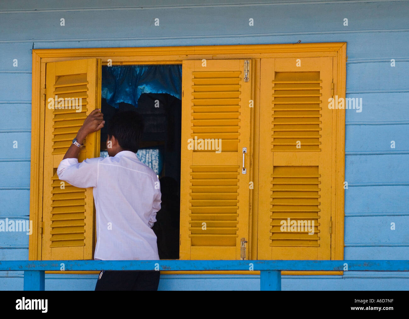 Talking through a housboat window in the Vietnamese floating village of ...