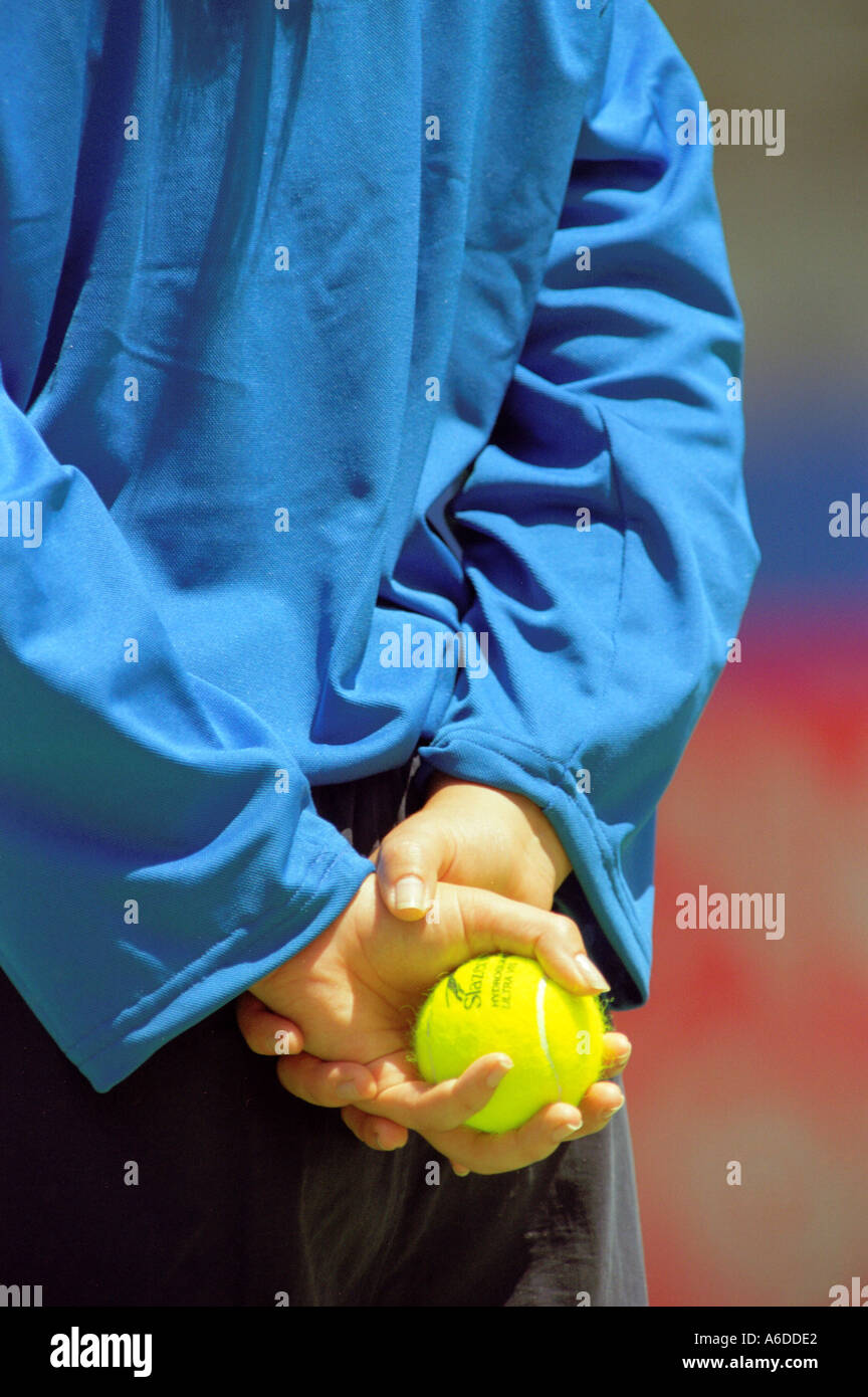 Tennis balls in hand Stock Photo - Alamy