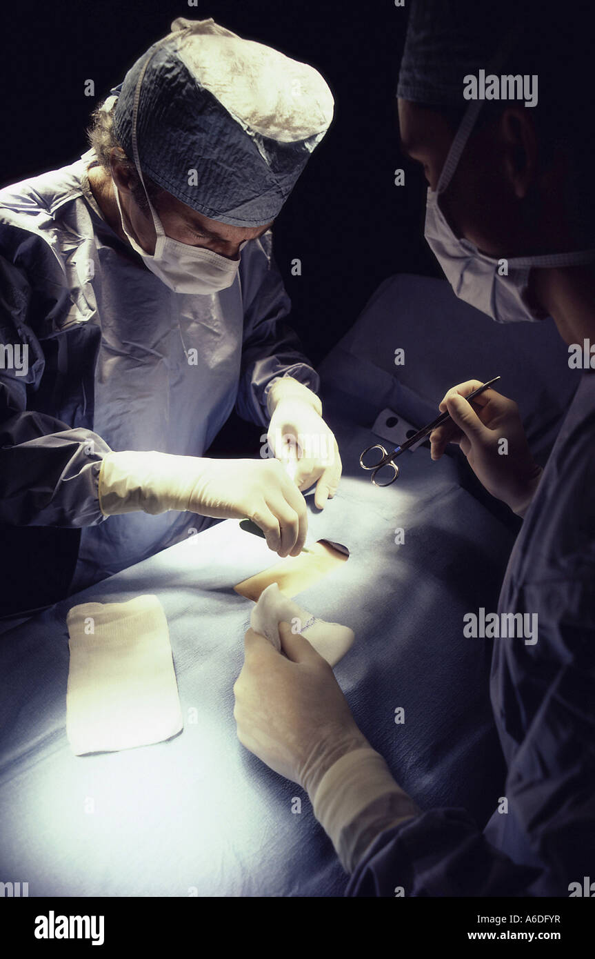 Surgeons operating in an operating room Stock Photo - Alamy