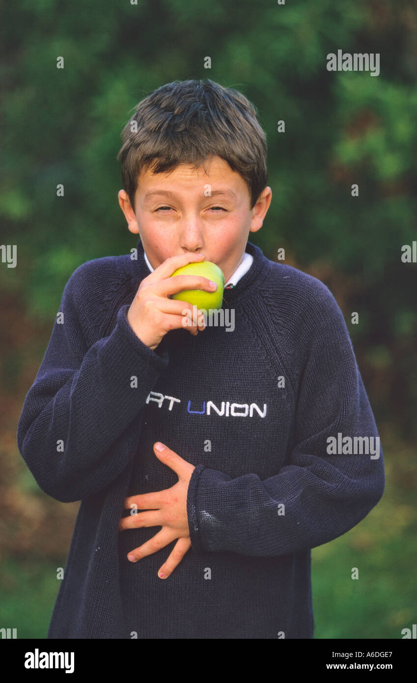 A child bites an apple Stock Photo - Alamy