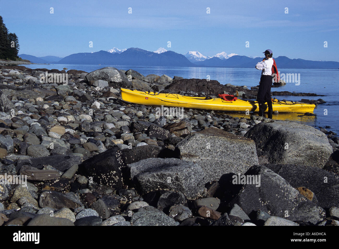 Alaska Point Adolphus near Glacier Bay Woman putting on life jacket ...