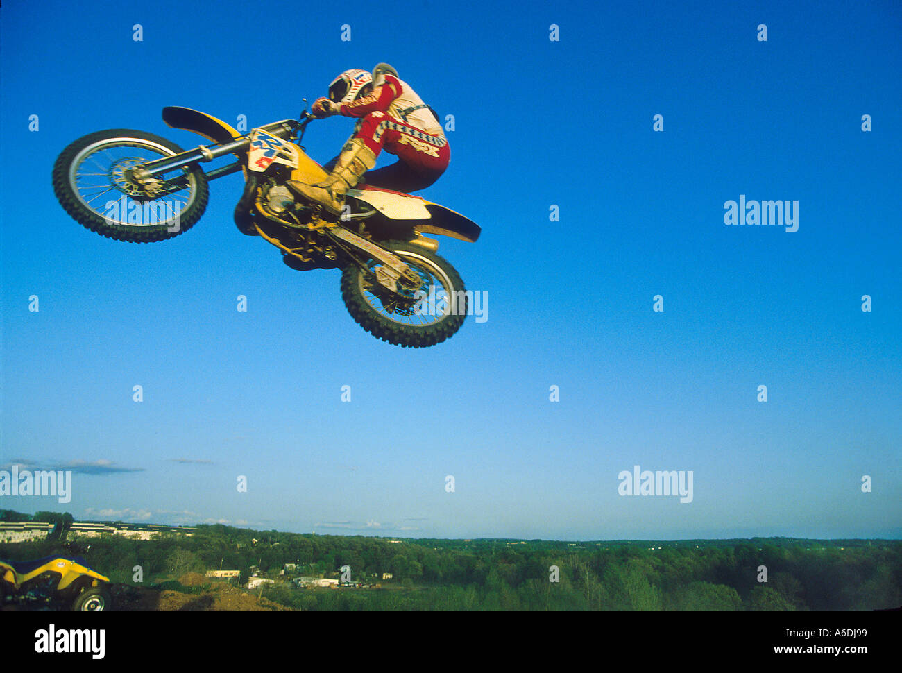 Motorcycle dirtbike flying through the air from off a dirt ramp Stock ...