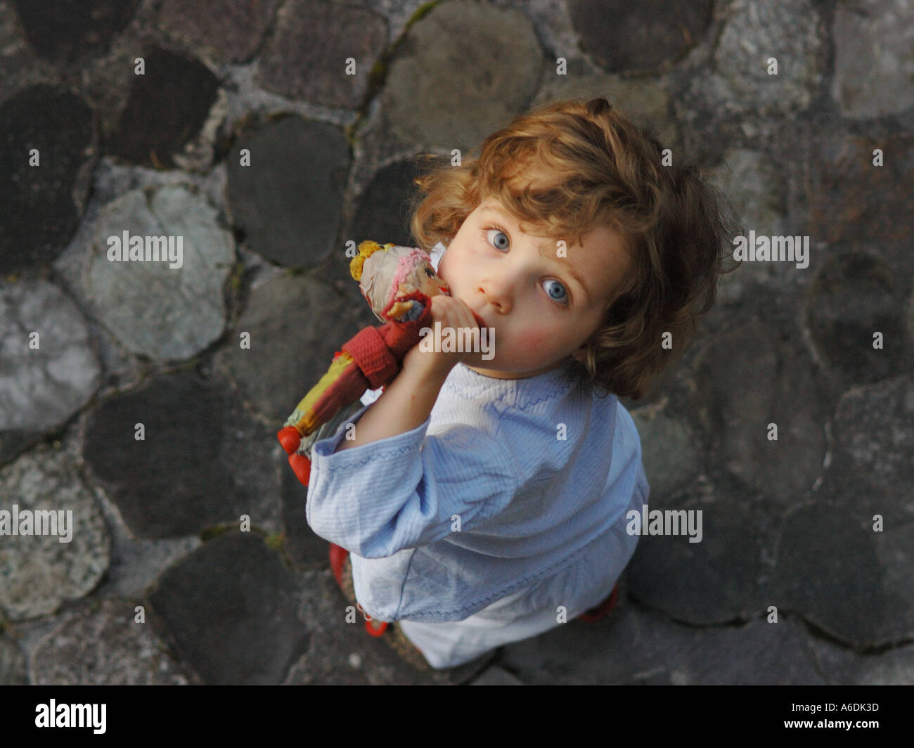 girl with curly hair thumb in her mouth Stock Photo - Alamy