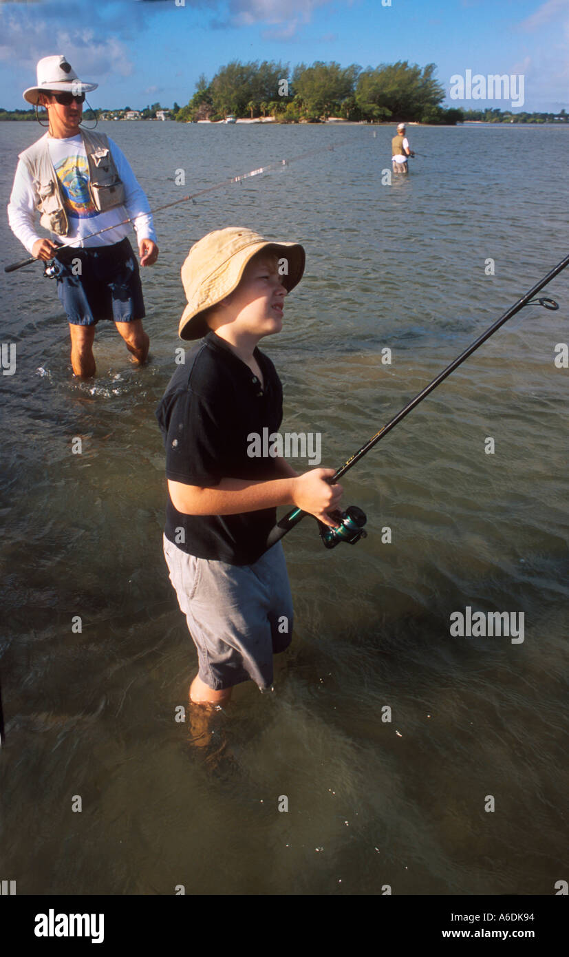 Boy fishing with men Saint Lucie Estuary Indian River Lagoon Martin ...