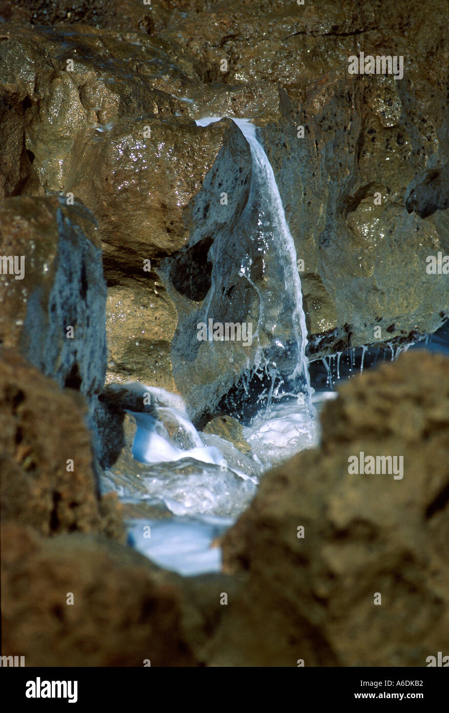 Water drains from a shoreline limestone cliff after being soaked by a ...