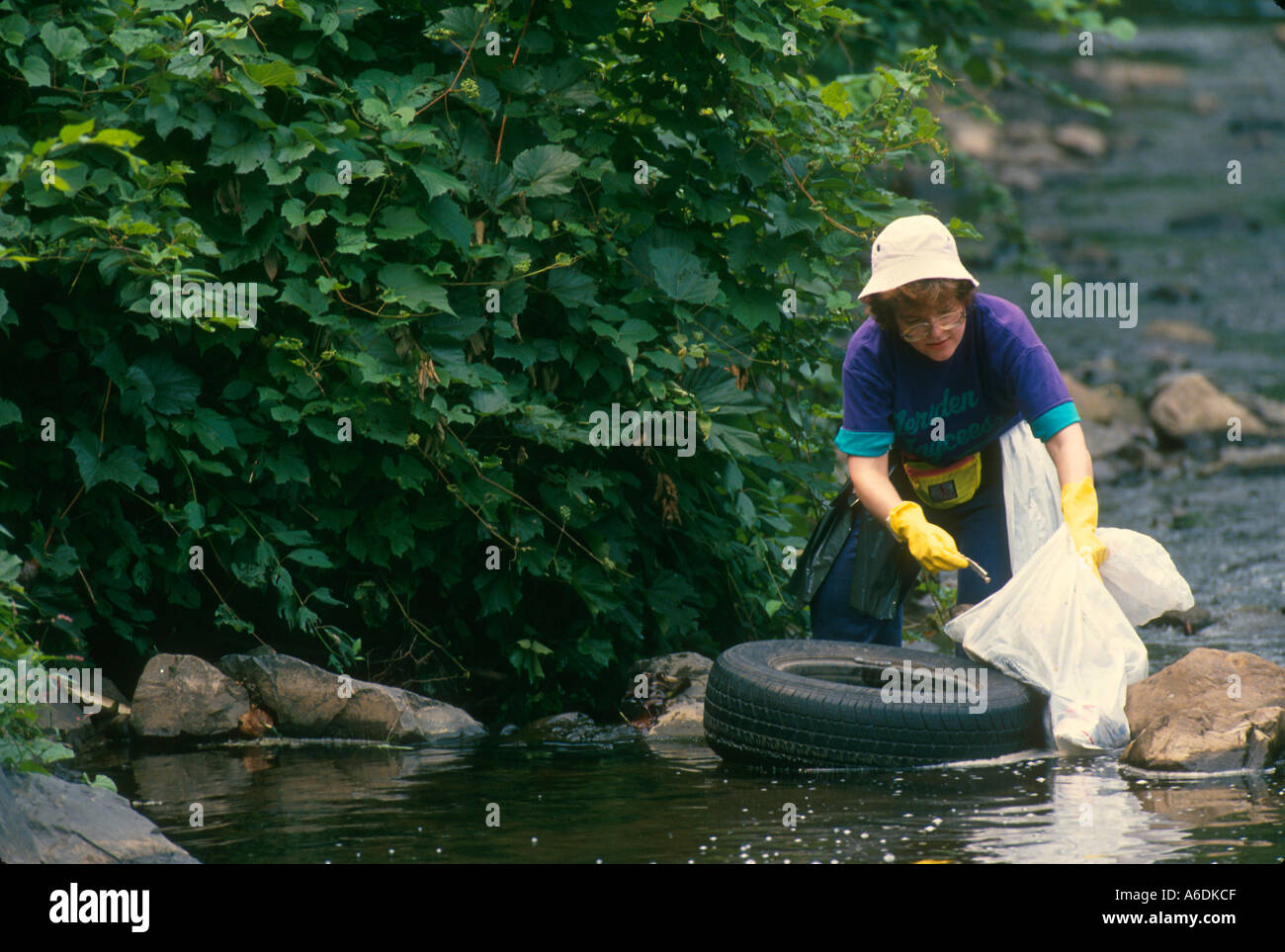 Women volunteer cleaning up garbage from a waterway in a Connecticut ...