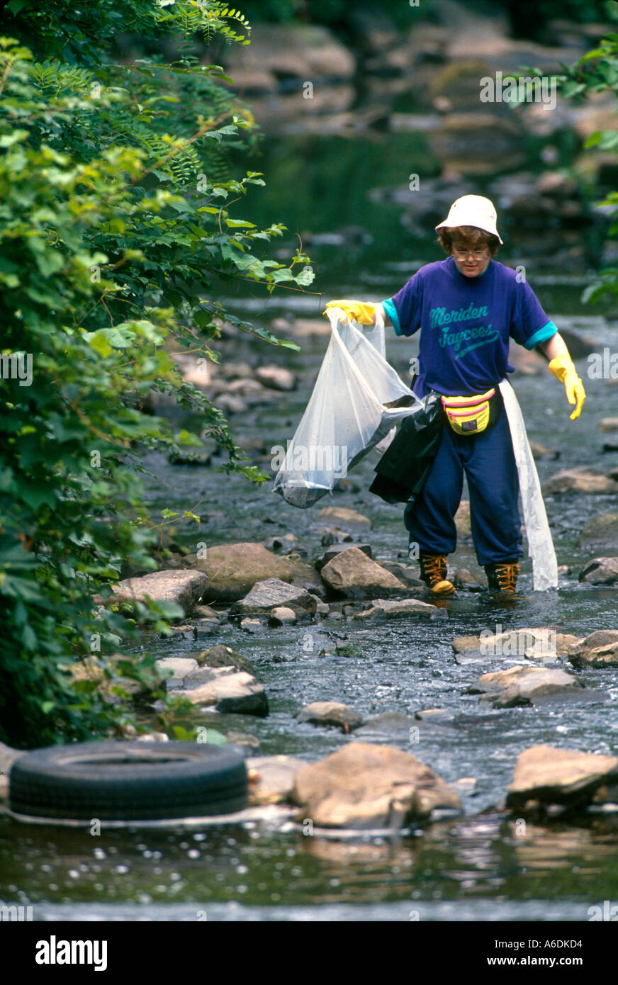 Women volunteer cleaning up garbage from a waterway in a Connecticut ...