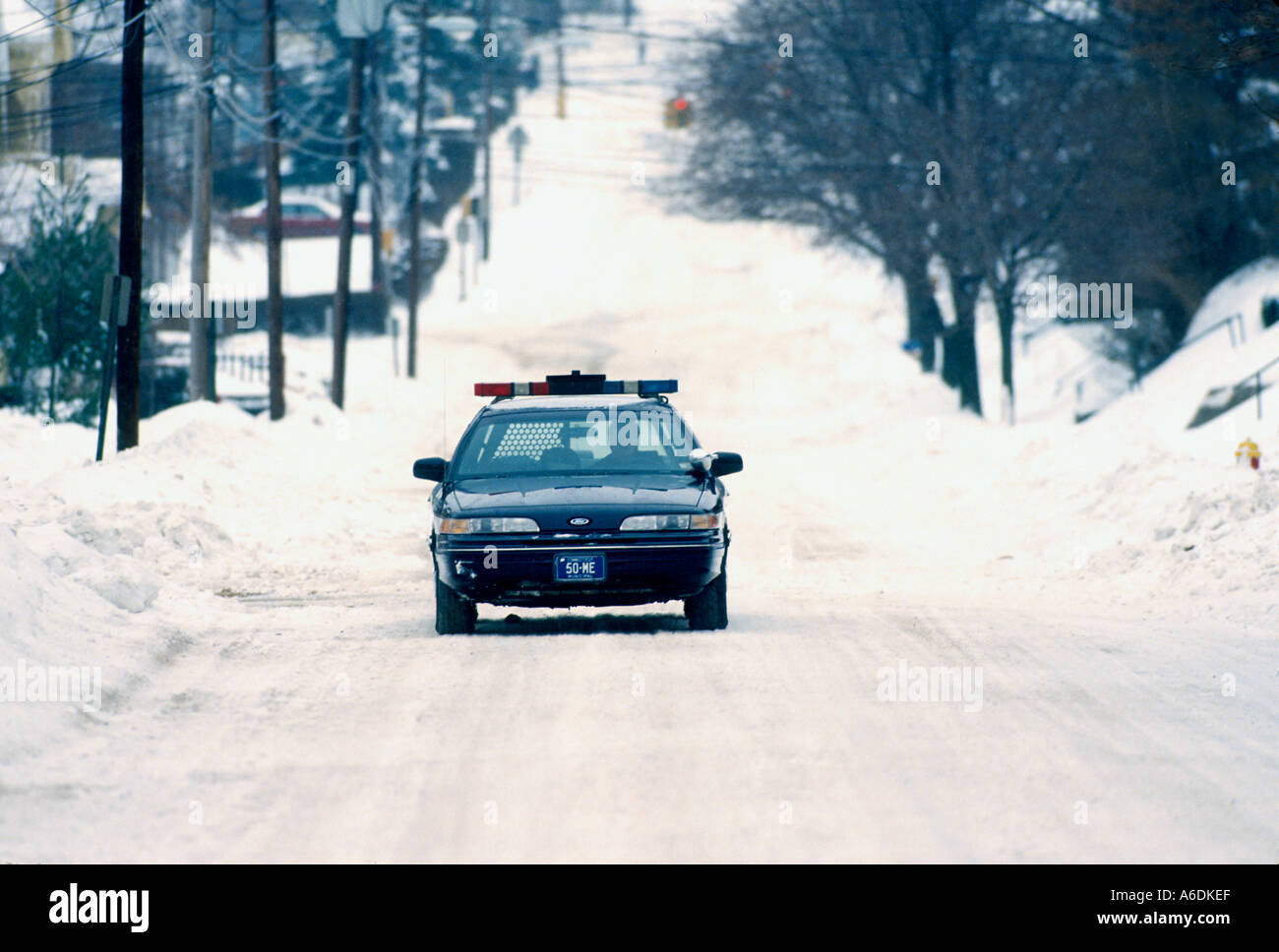 Police officer patrol car on snowy city street Stock Photo - Alamy