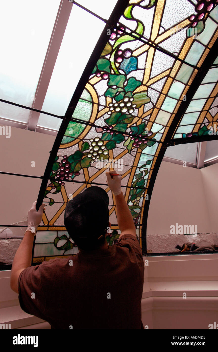 Workers install stained glass panels int eh lobby of the Carlton Hotel ...