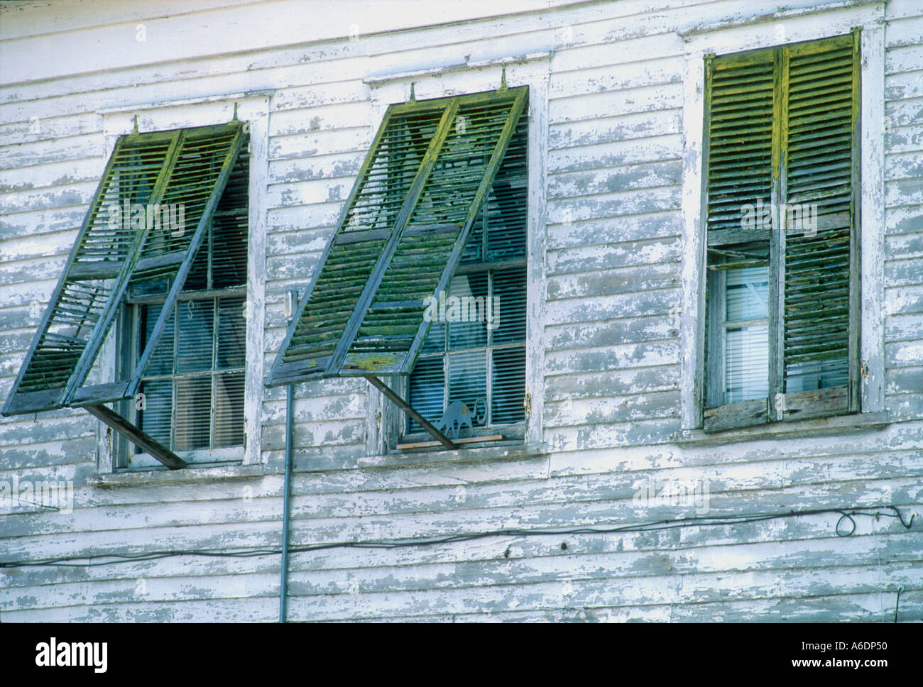 Key West home worn weathered paint and broken shutters Stock Photo - Alamy