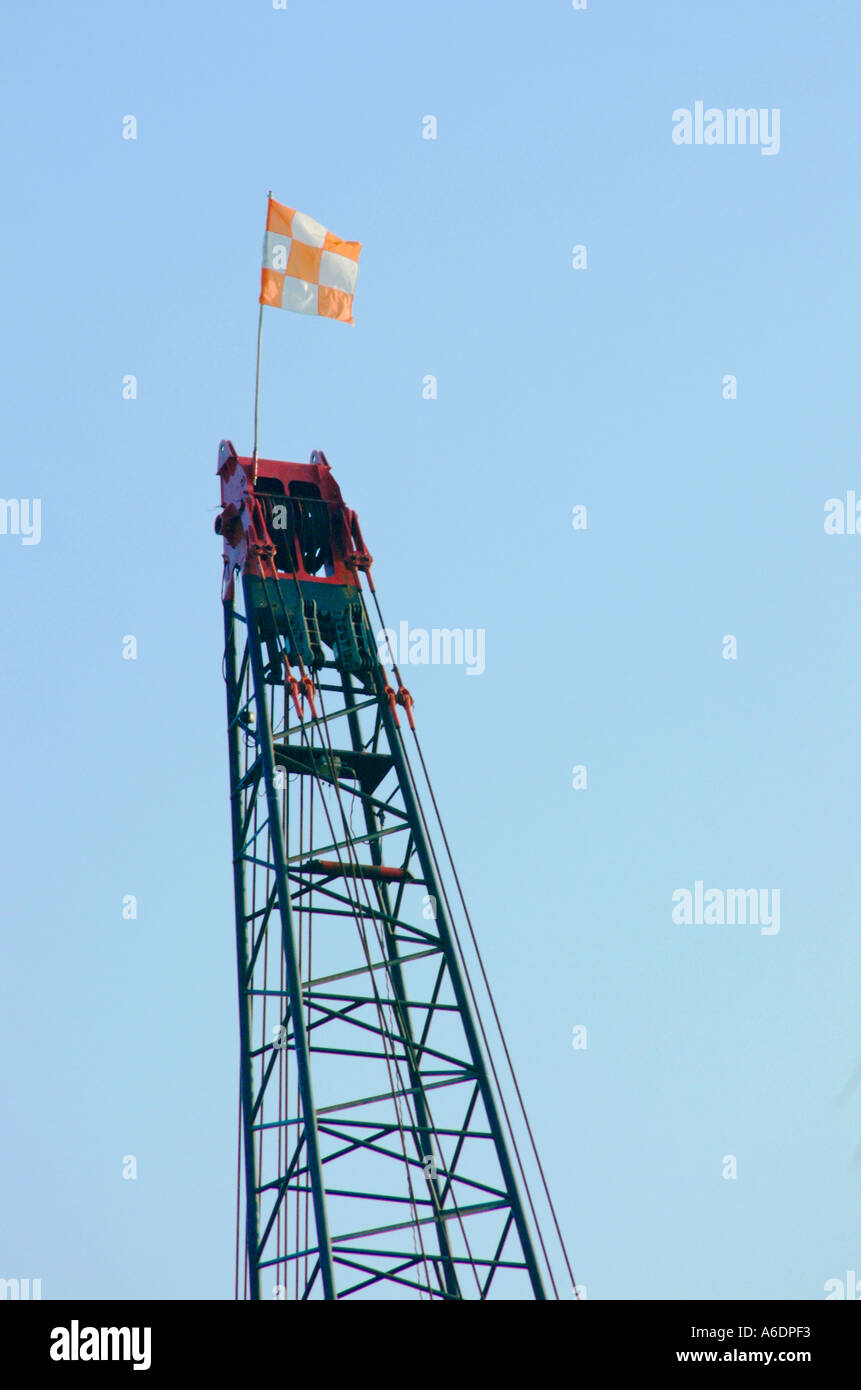 Orange and white checkered safety flag on a crane near an international ...