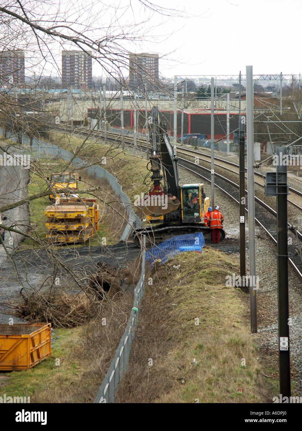 A mechanical digger working alongside the railway during improvement ...