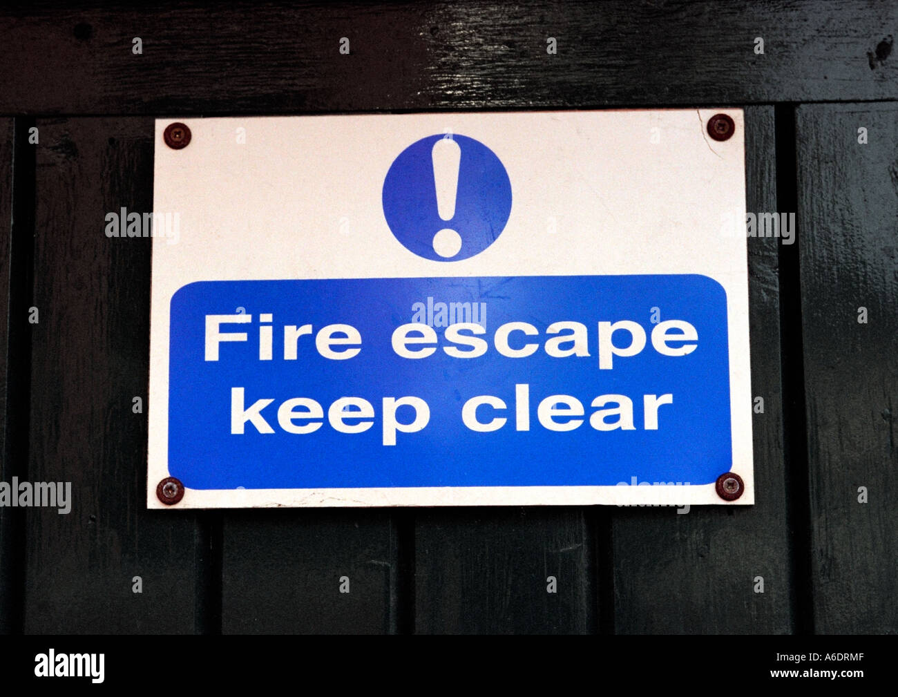 Fire escape sign on wooden door Stock Photo - Alamy