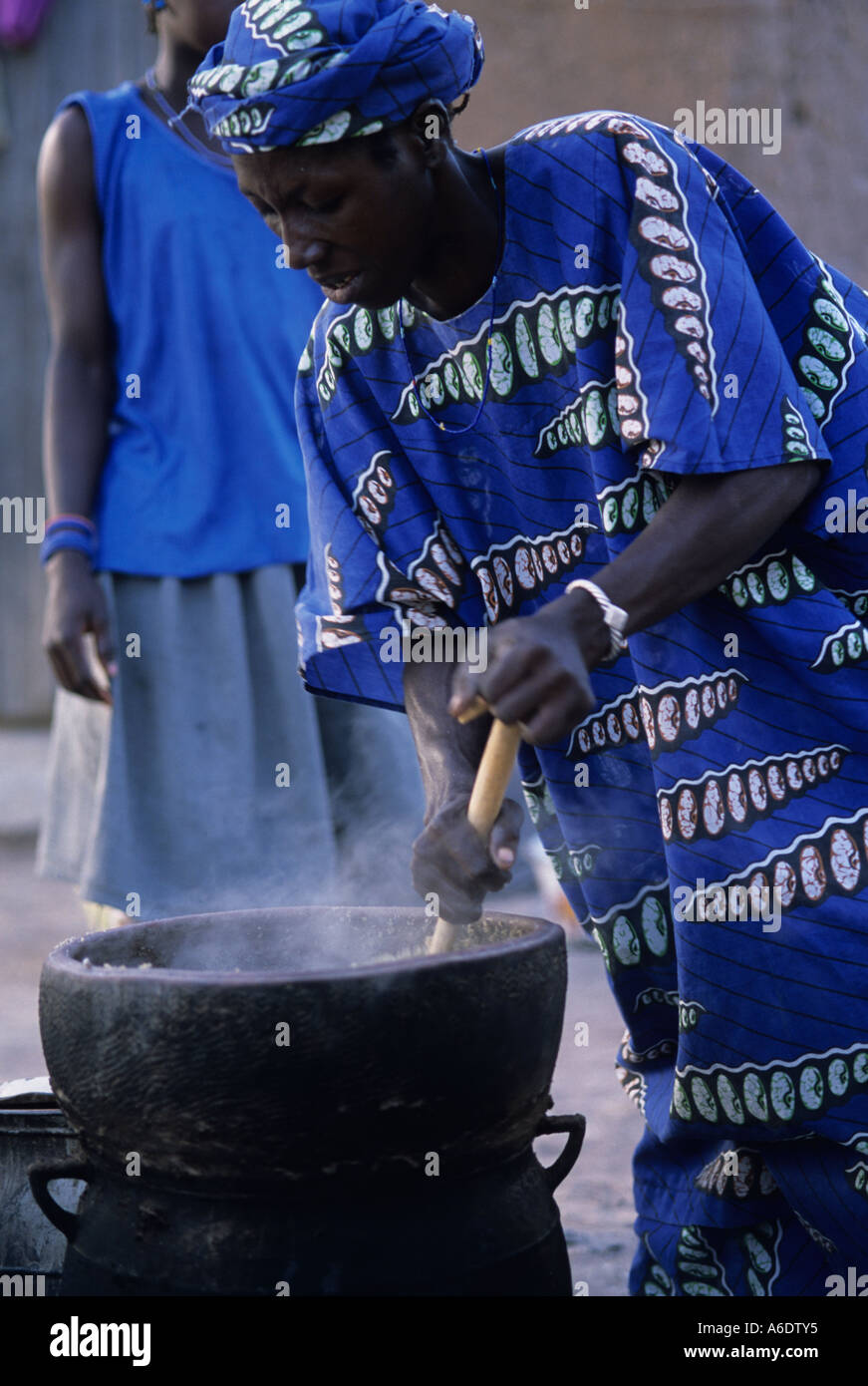 A woman cooking maize Salia in the Beleco region Mali Stock Photo - Alamy