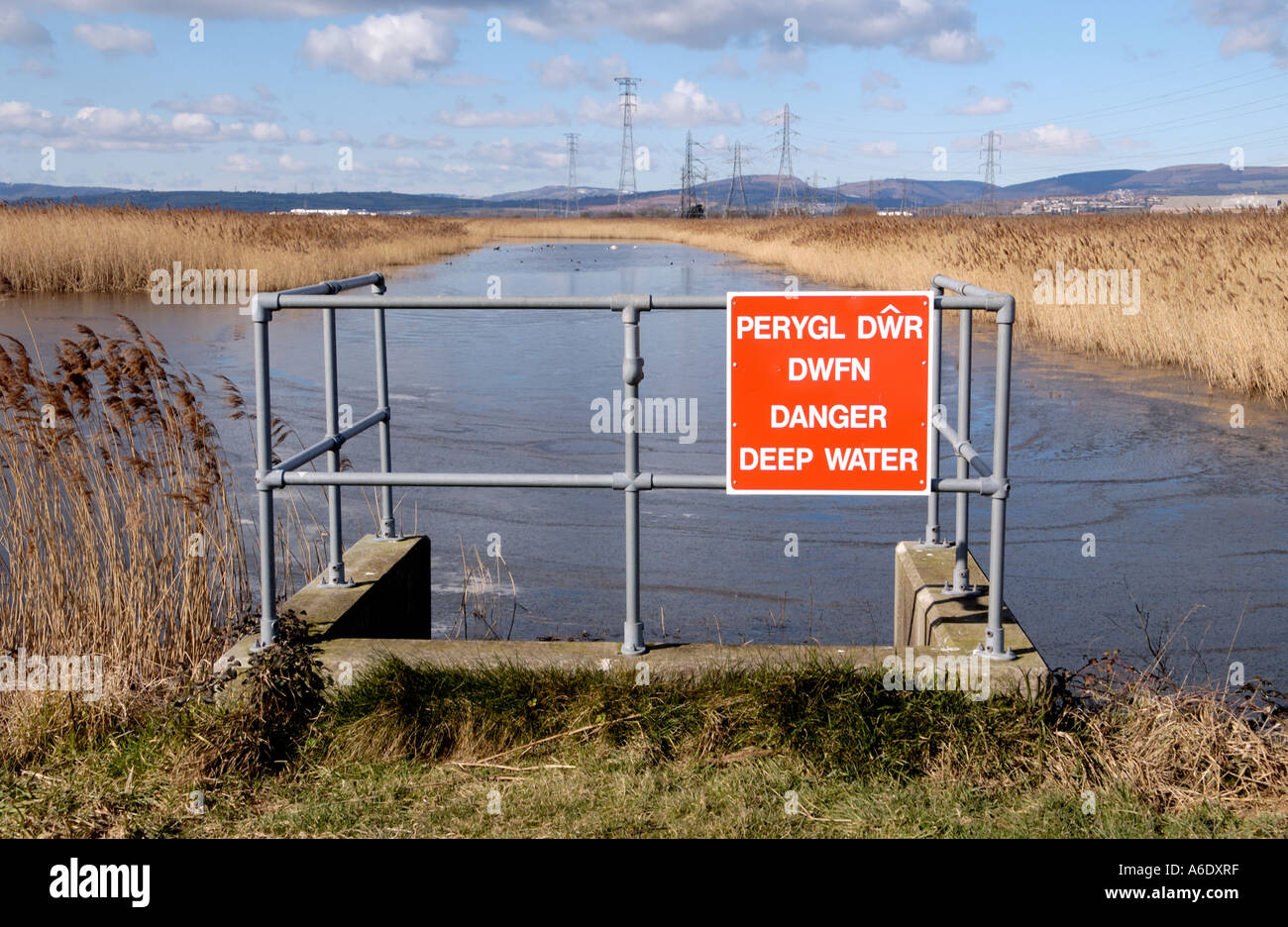 Bilingual Welsh English language DANGER DEEP WATER sign at lagoon ...