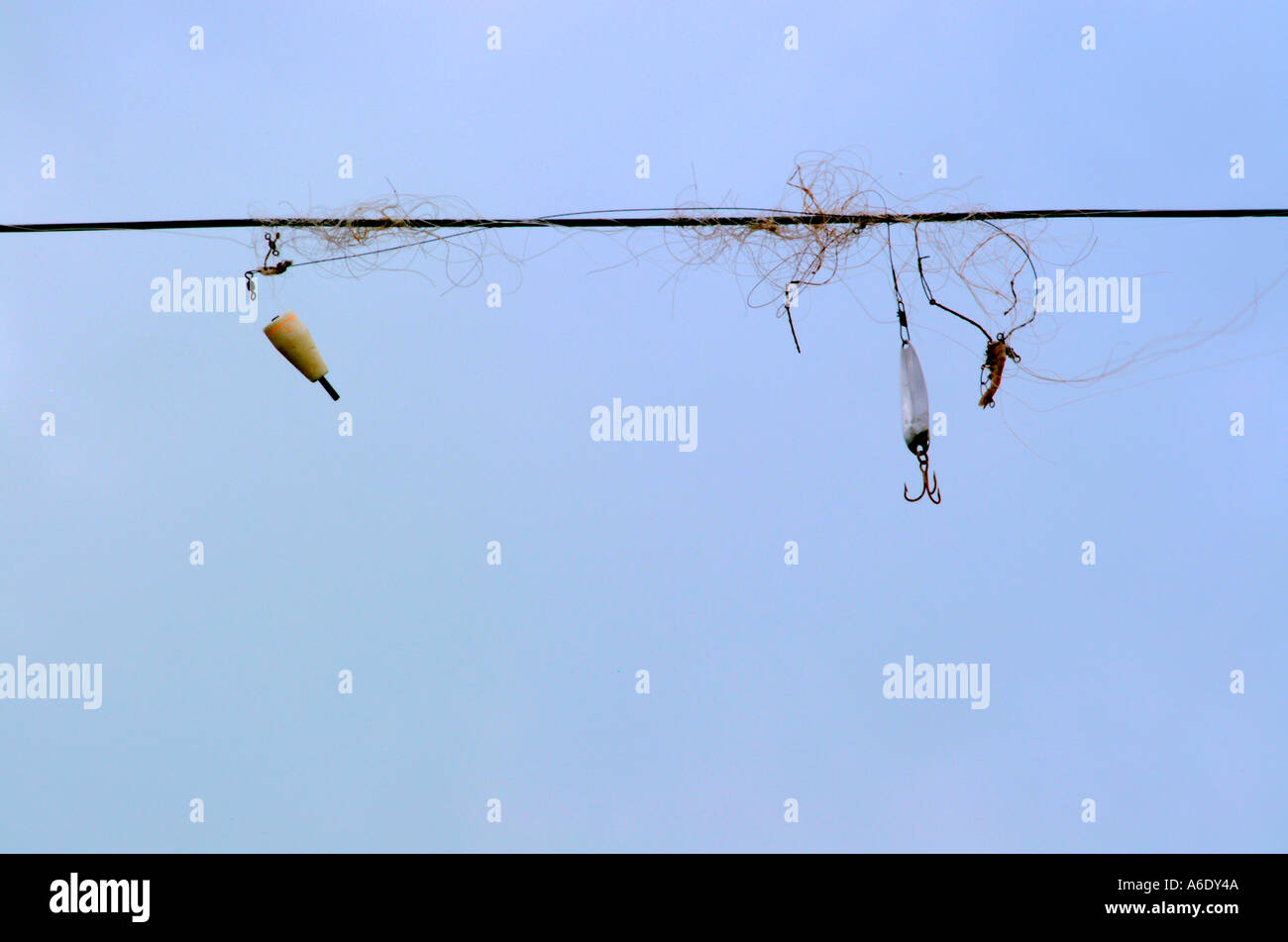 Fishing tackle lures wrapped around power line garbage trash Stock ...