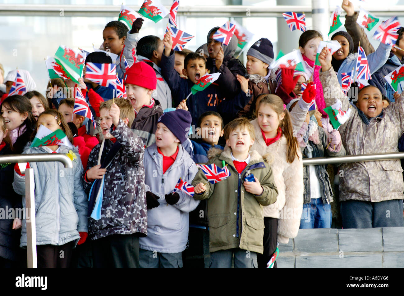 Primary school children wave flags at the opening of the Senedd ...