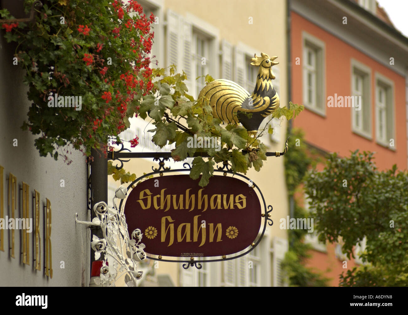 A traditional sign, elaborate and decorative hanging outside a shop in ...