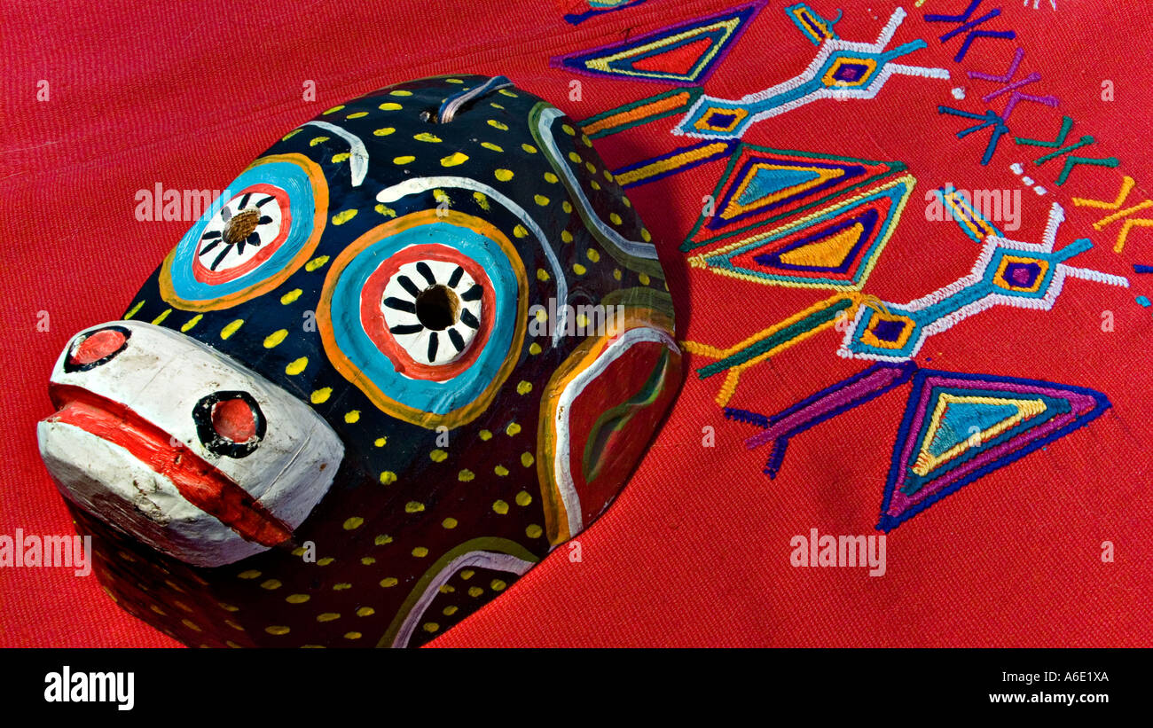 Guatemalan wooden dance mask of a monkey against a red brocaded Maya ...