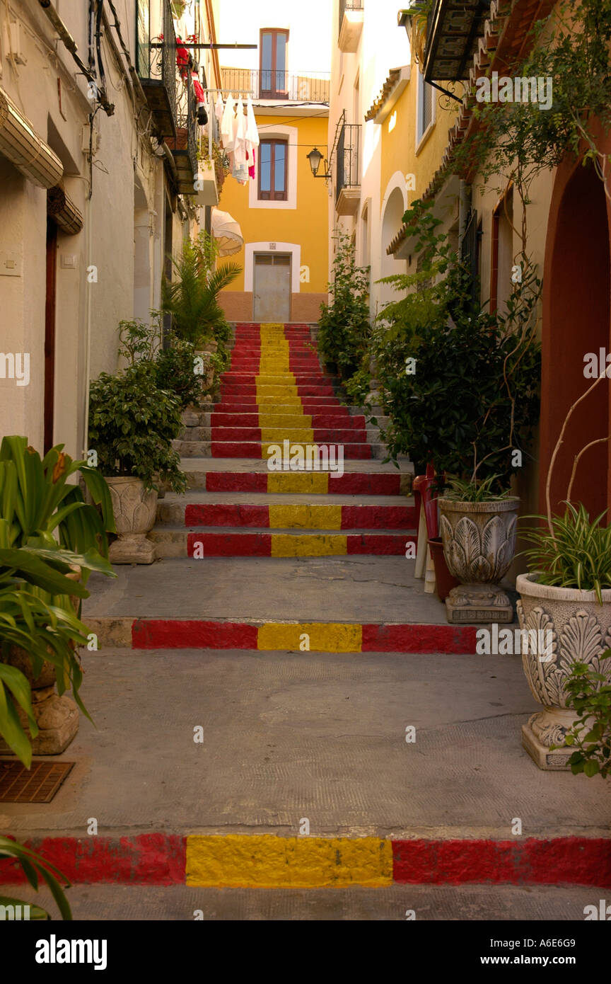 Steep lane with stairway steps in the Spanish national colors, old part ...