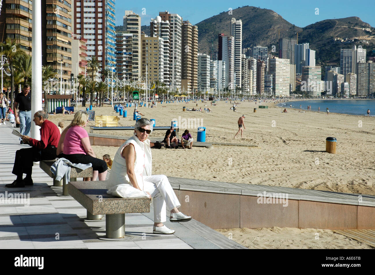 Older lady at the bank promenade, Playa de Levante, Benidorm, Costa ...