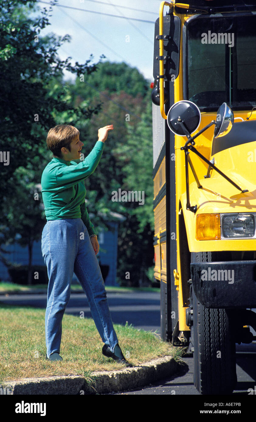 Caucasian mom waving goodbye to student on school bus Stock Photo - Alamy