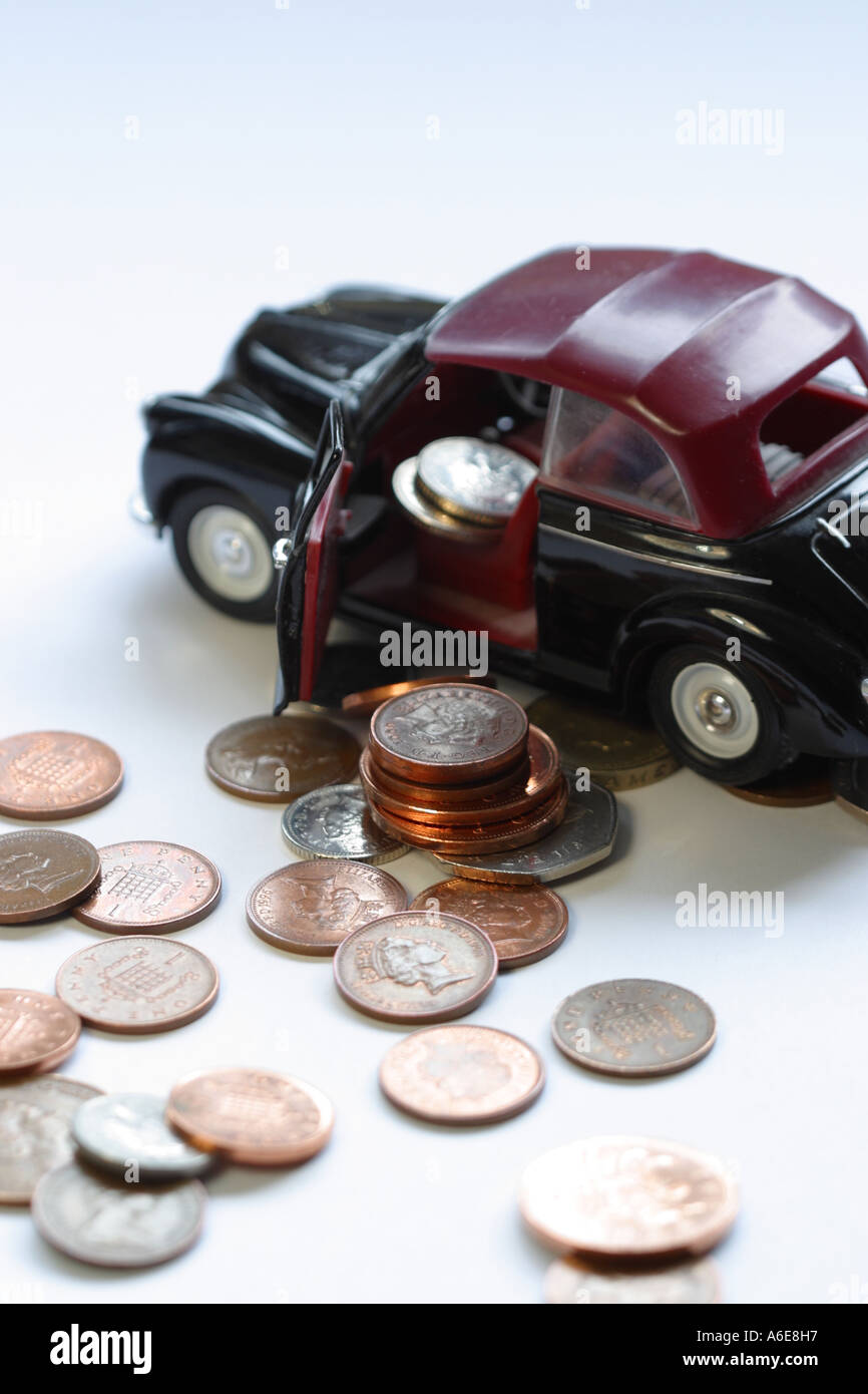 Toy car with cash coins Stock Photo - Alamy