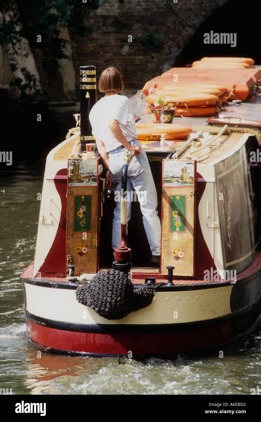 A woman steers a narrowboat towards Maida Tunnel on the Regents Canal ...