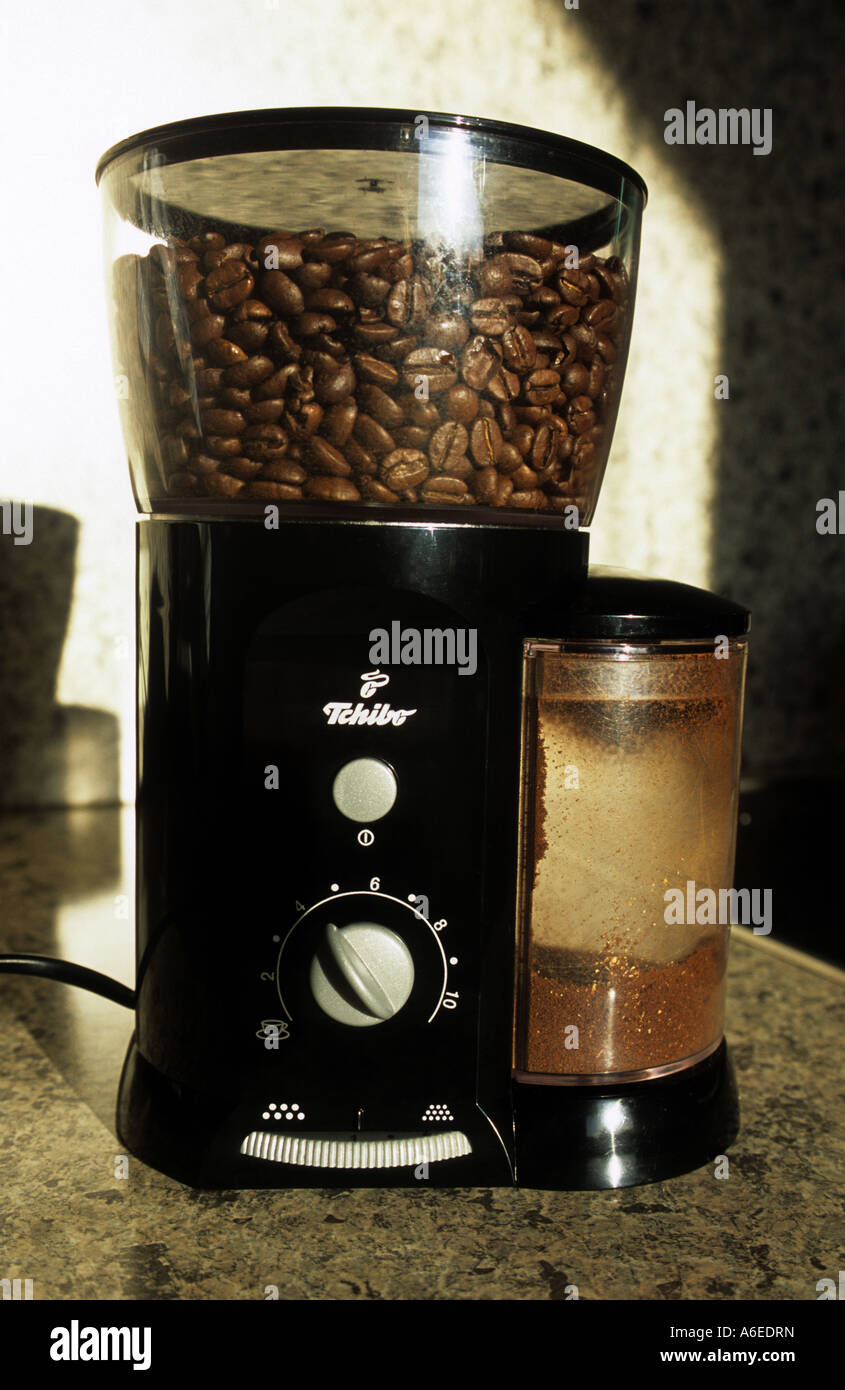 Roasted coffee beans in an Tchibo electric grinder Stock Photo - Alamy