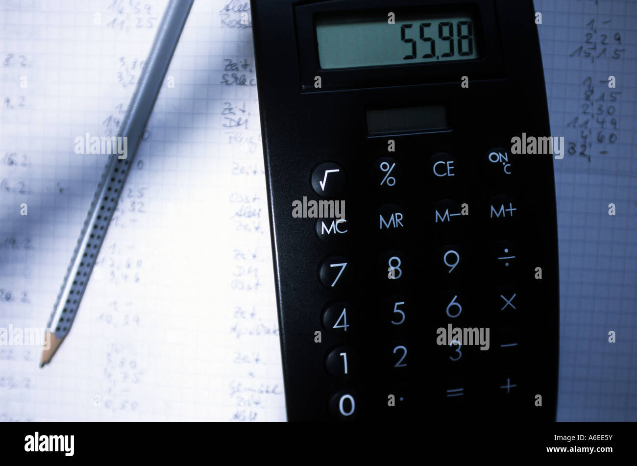 Electonic desktop calculator being used to calculate monthly household ...