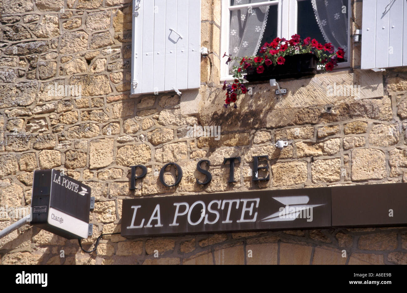 French post office sign La Poste above shop fixed to stone wall below ...