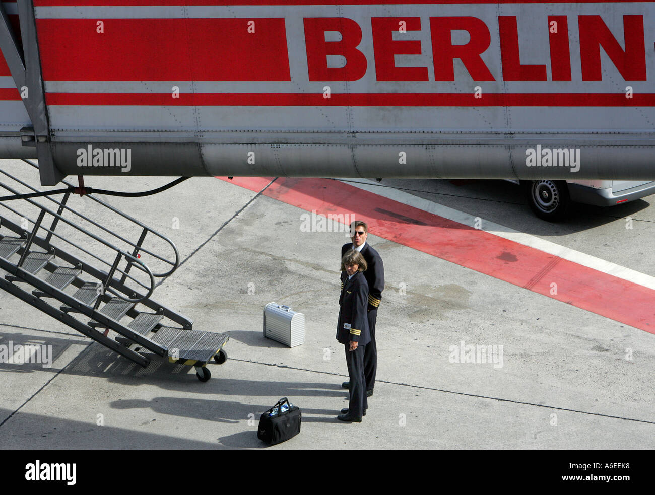Captain and female co captain standing underneath a boarding bridge at ...