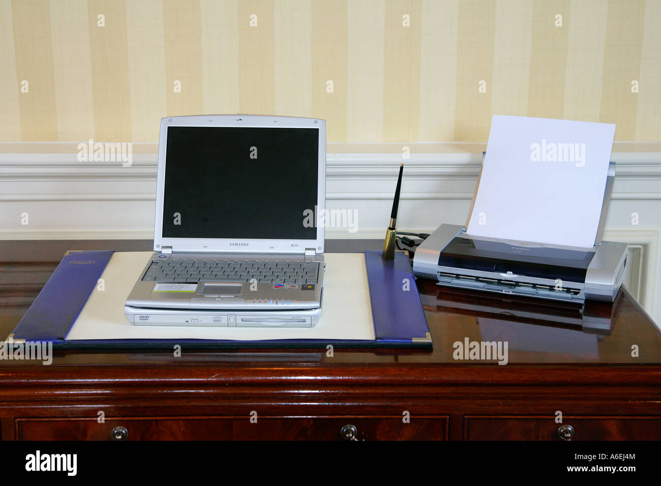 Laptop computer on hotel desk reception Stock Photo - Alamy