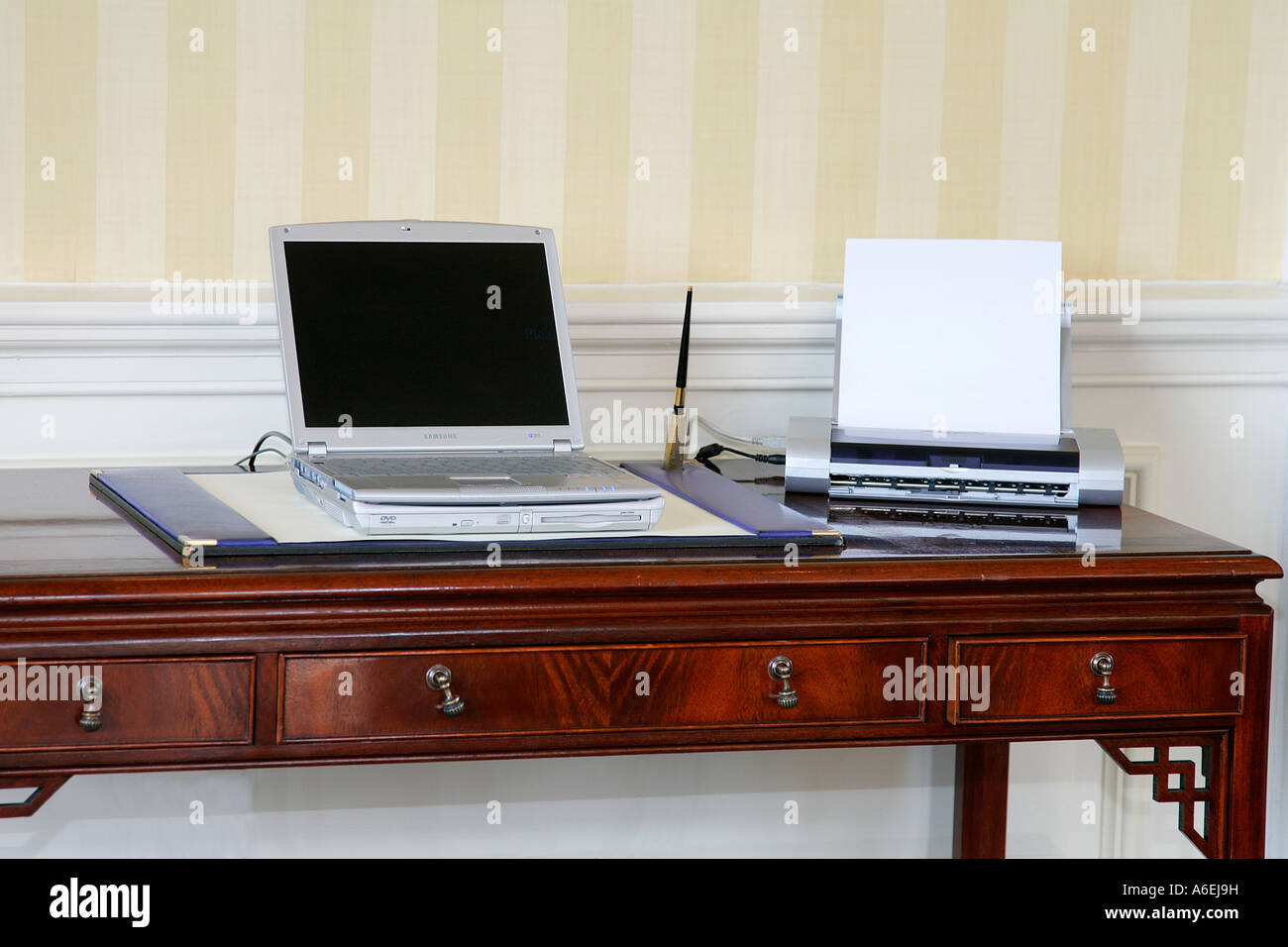 Laptop computer on hotel desk reception Stock Photo - Alamy