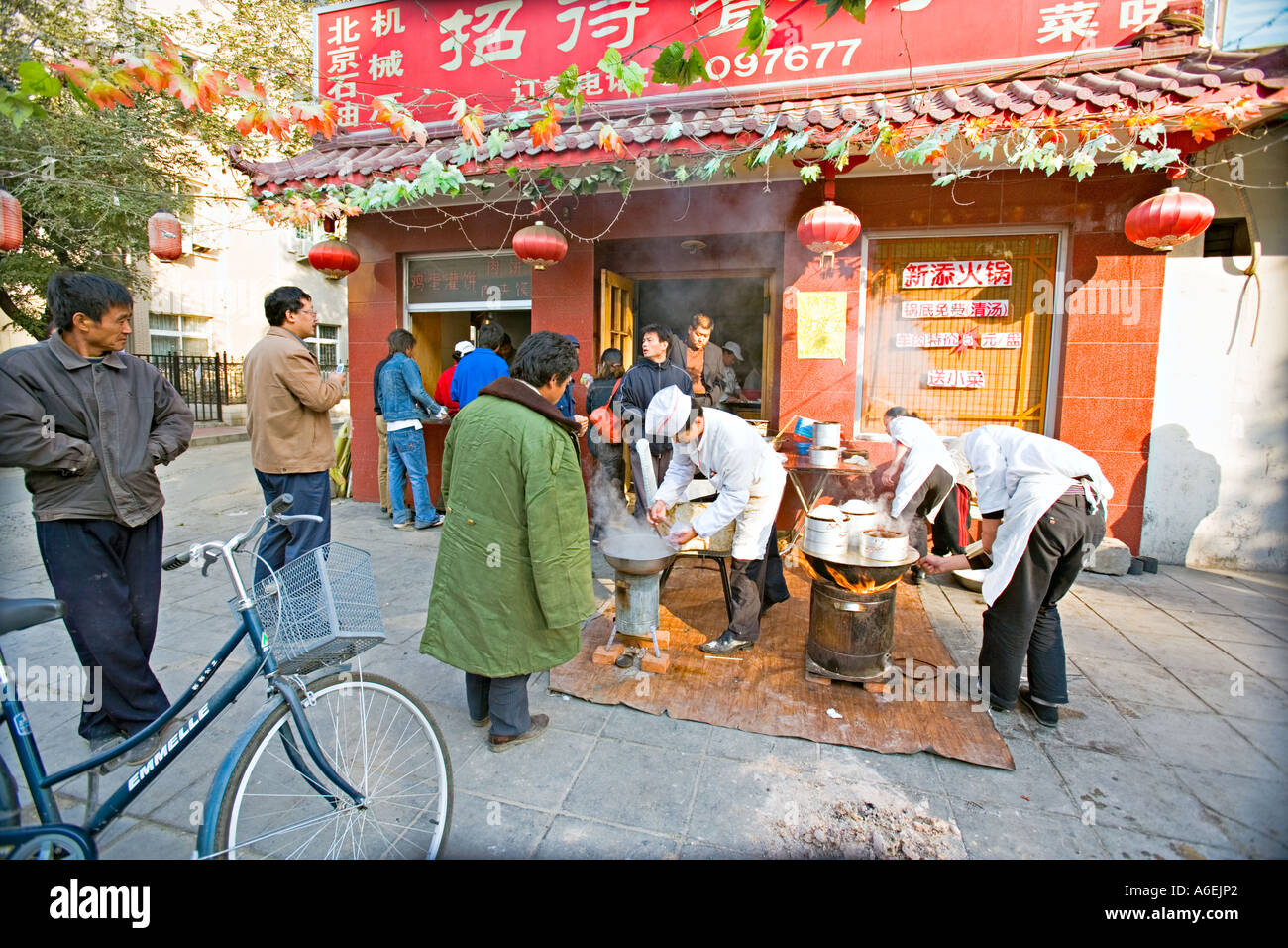 CHINA BEIJING Tiny but busy neighborhood restaurant with chefs set up ...