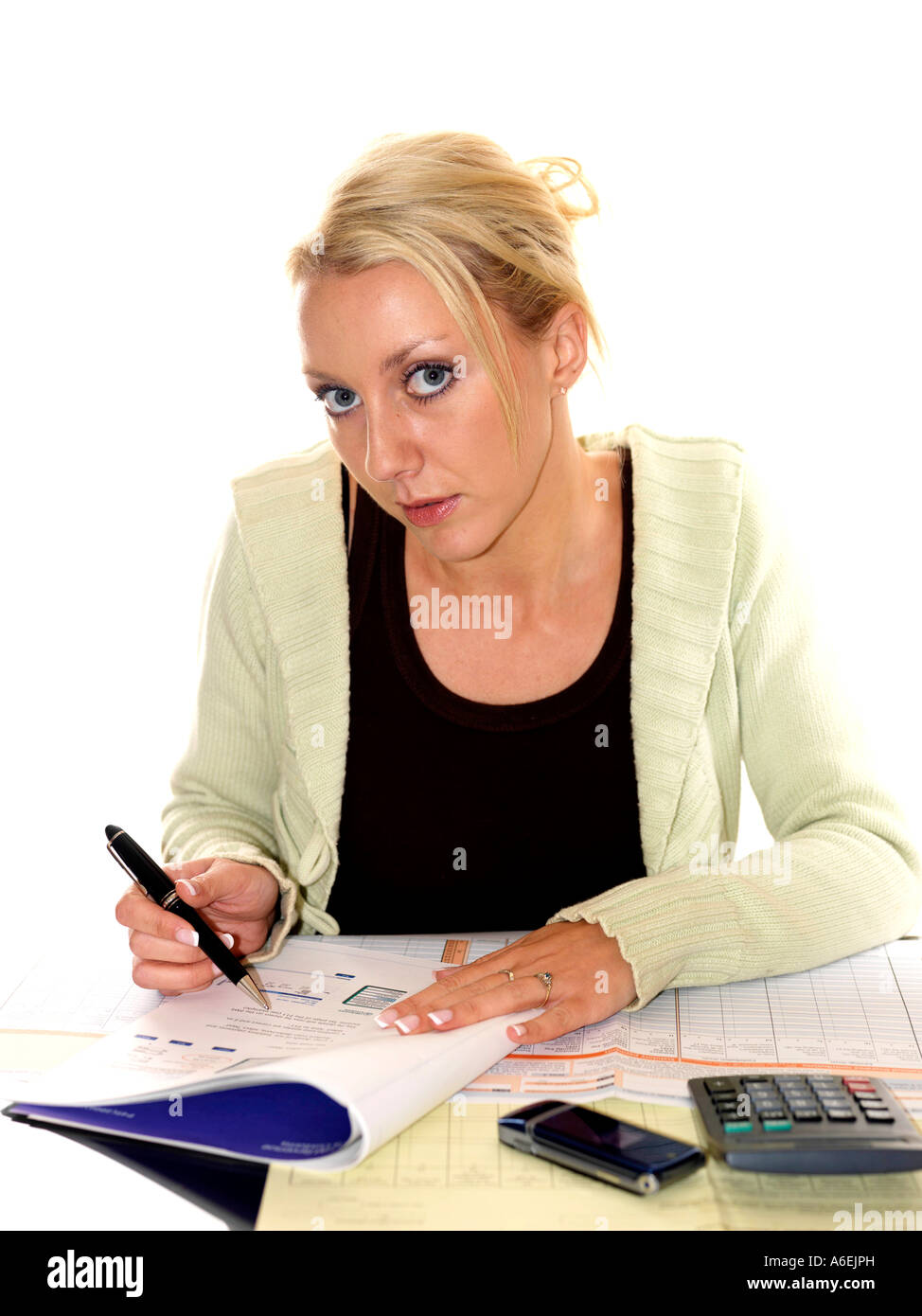 Young Woman Working Though And Calculating Her Annual Income Tax Return ...